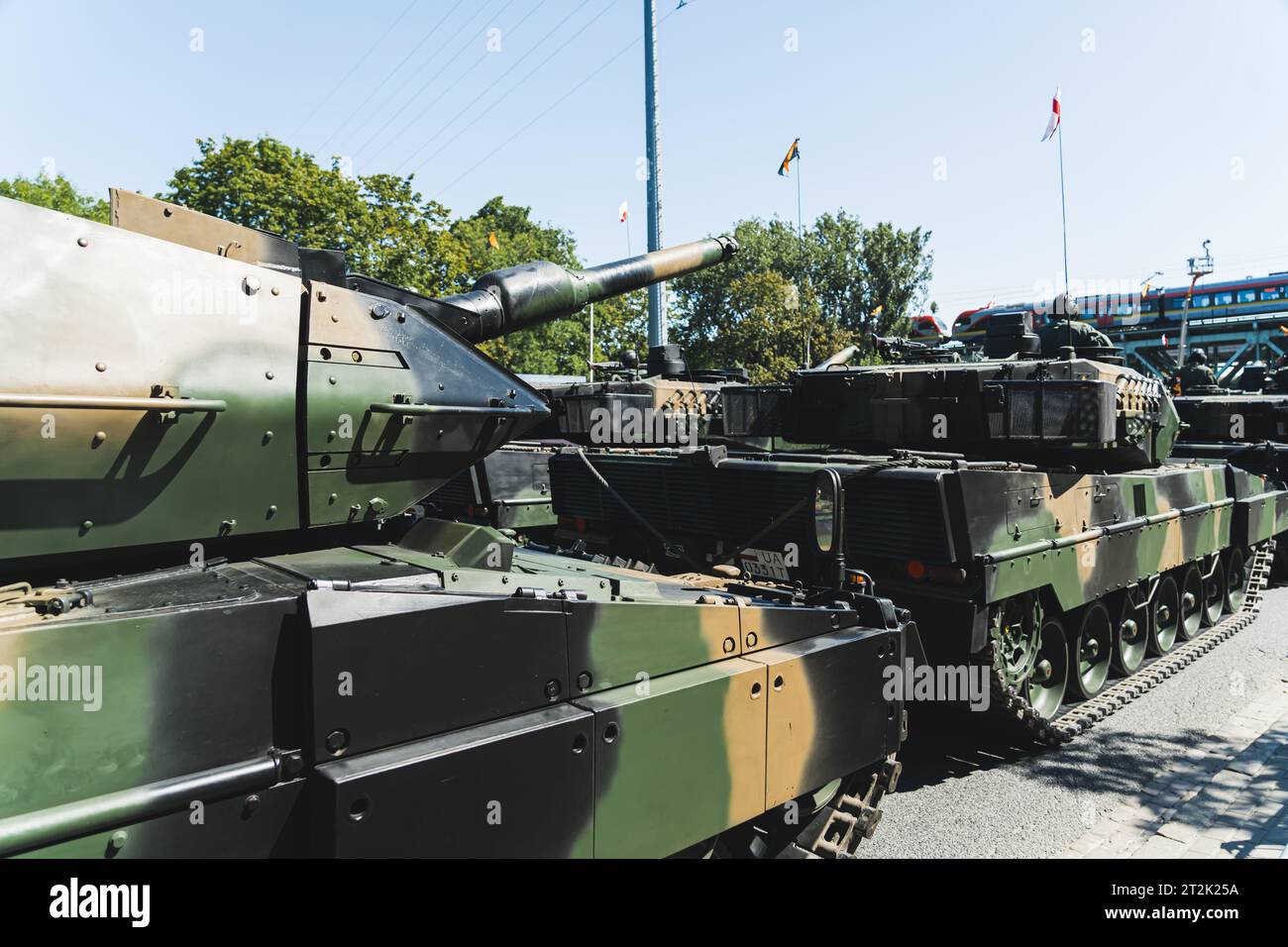 Back view of armoured combat heavy vehicle moving in a convoy during a ...