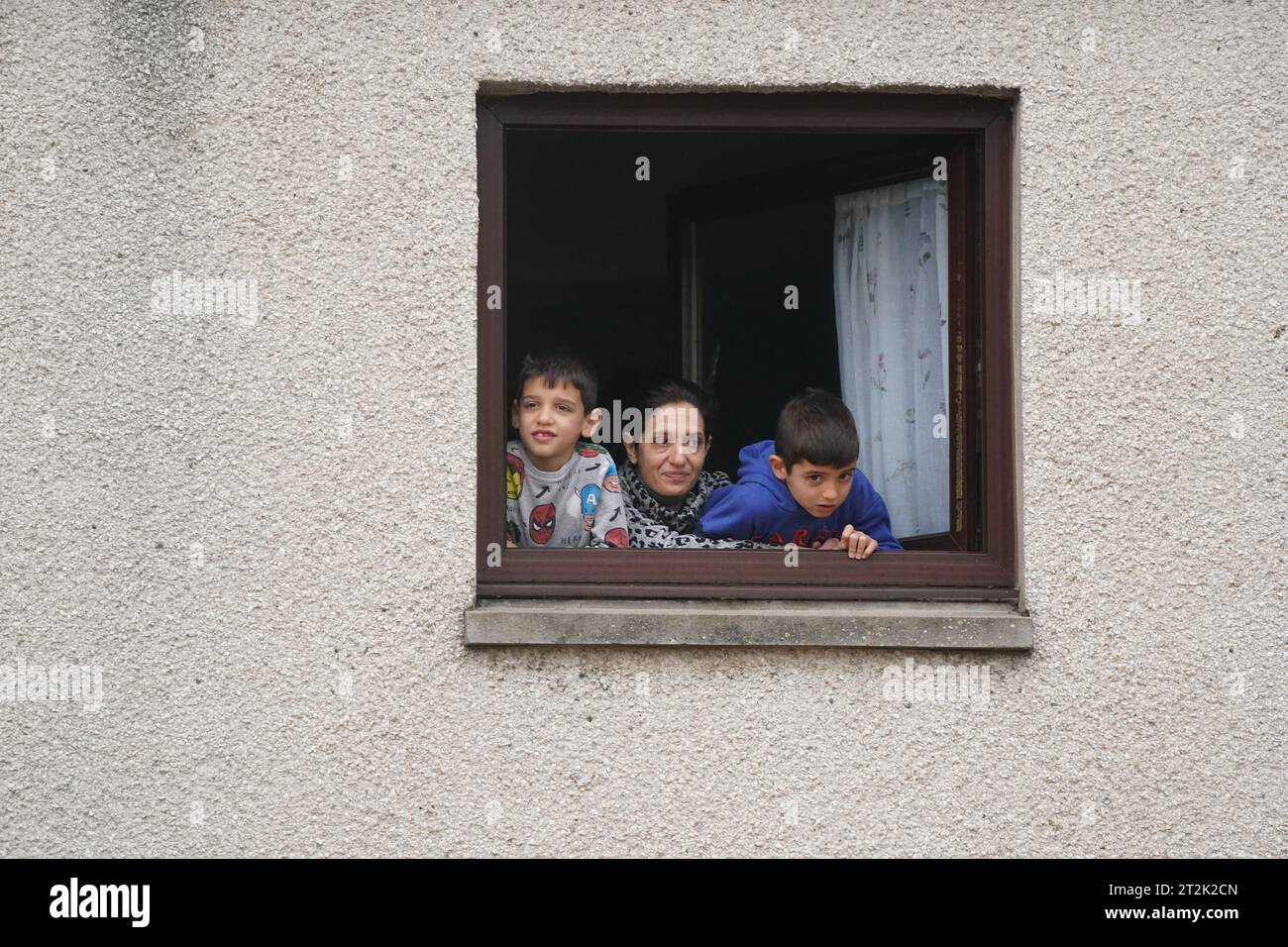 People look out of a window at flood water in Brechin, Scotland, as ...