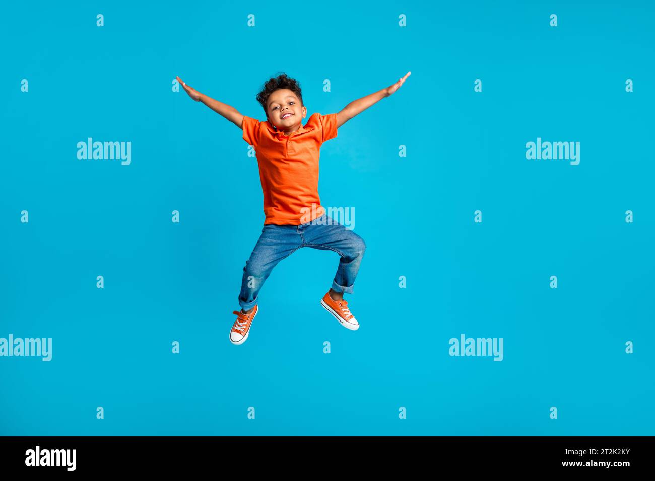 Full body cadre of jumping energetic latin small kindergarten age boy ...