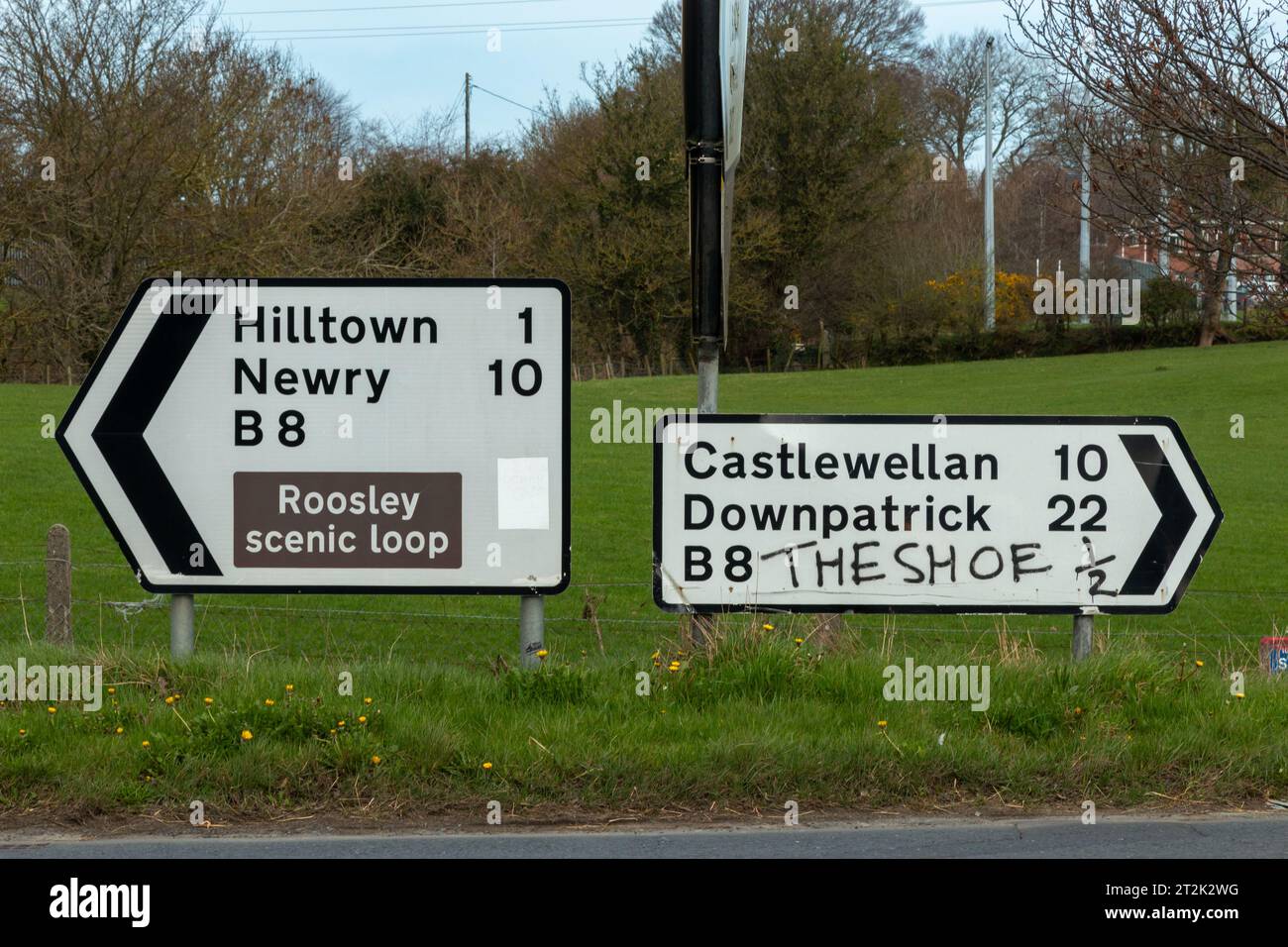 Road signs with quirky graffiti advertising a local pub outside the ... Road signs with quirky graffiti advertising a local pub outside the ...