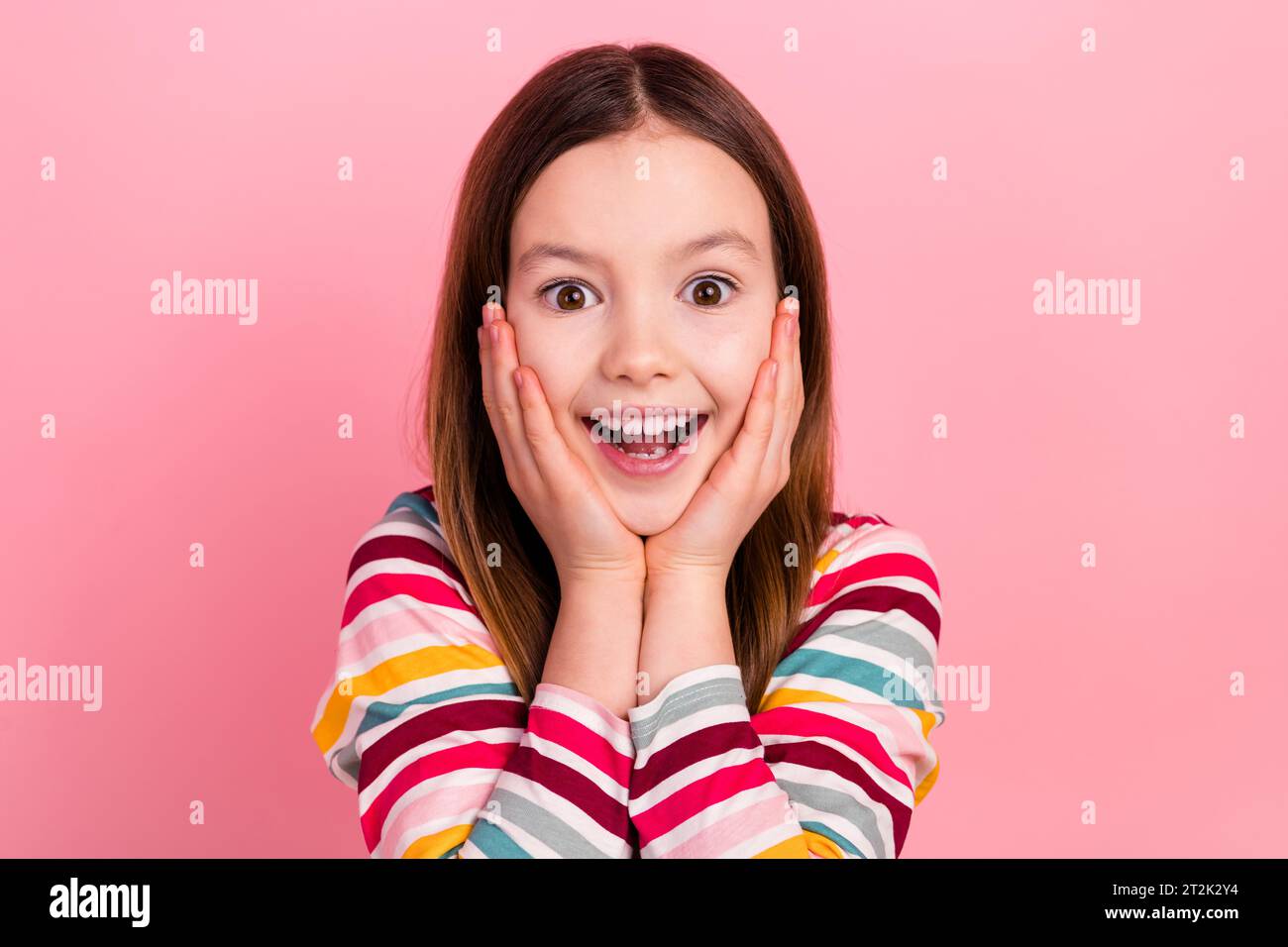 Photo of beautiful little cute funny kid girl hands touch cheekbones ...