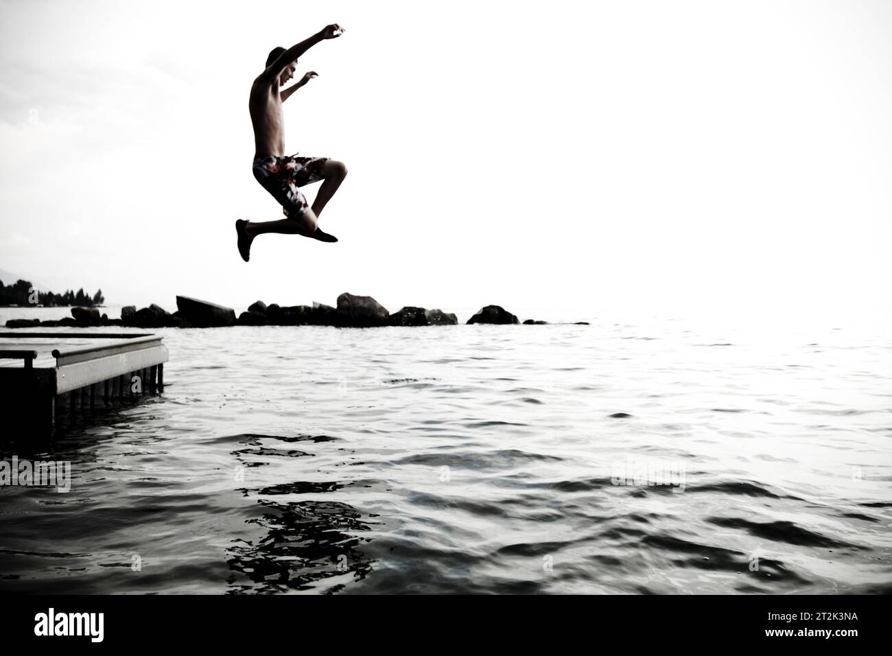 Boy jumping off pier hi-res stock photography and images - Alamy