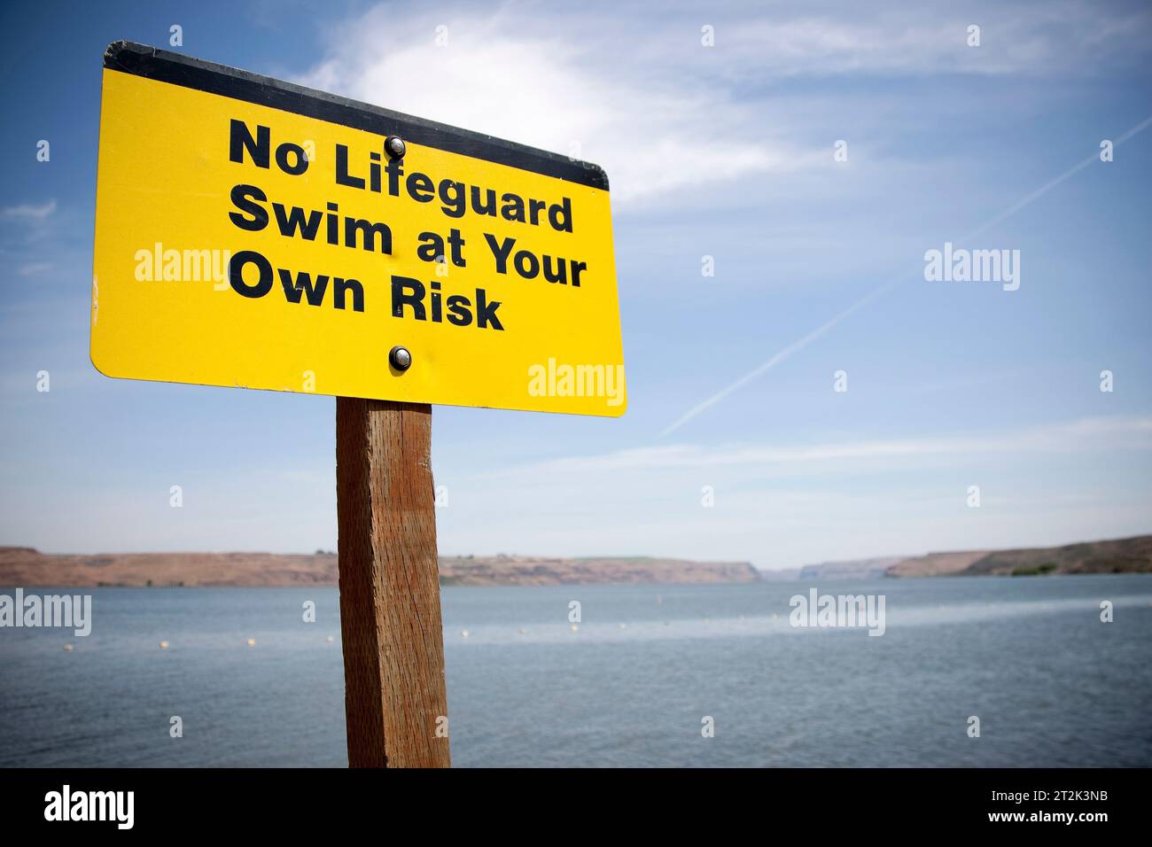 No Lifeguard Swim at Your Own Risk sign posted at a swimming area along ...
