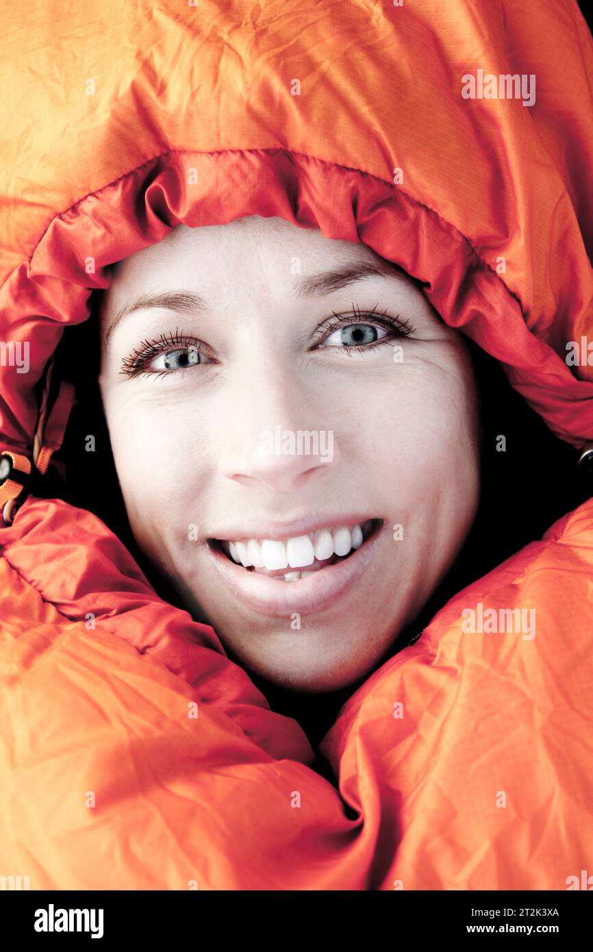 A woman with bright blue eyes looks directly into the camera while ...