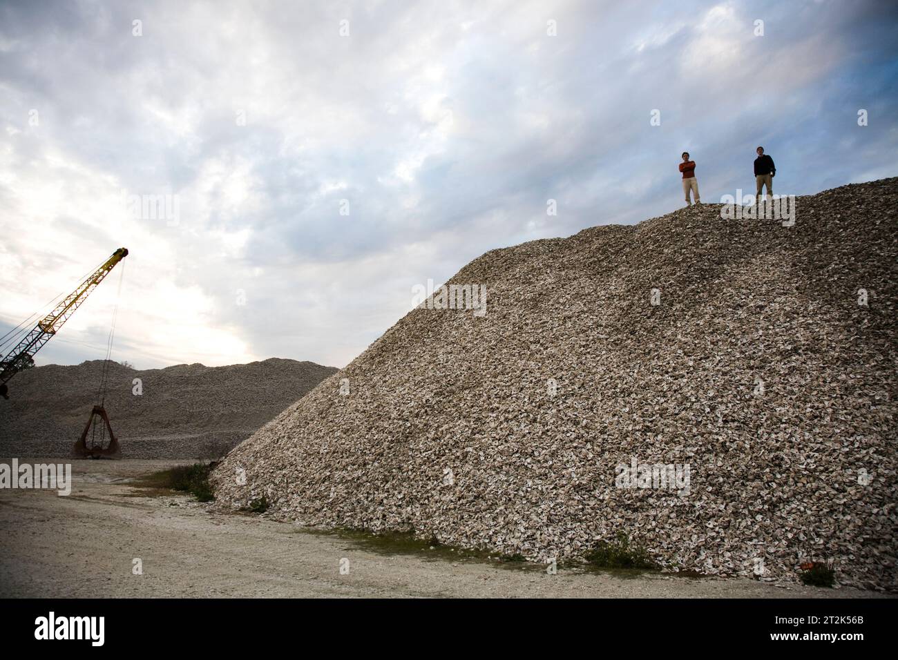 Two men stand atop a pile of oyster shells in Apalachicola, FL Stock ...