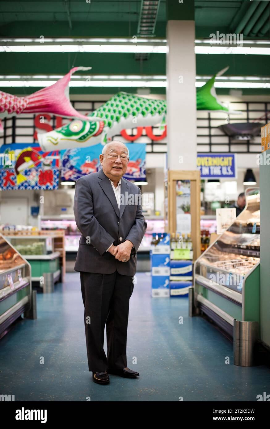 A portrait of an owner of a large grocery store standing in an aisle ...