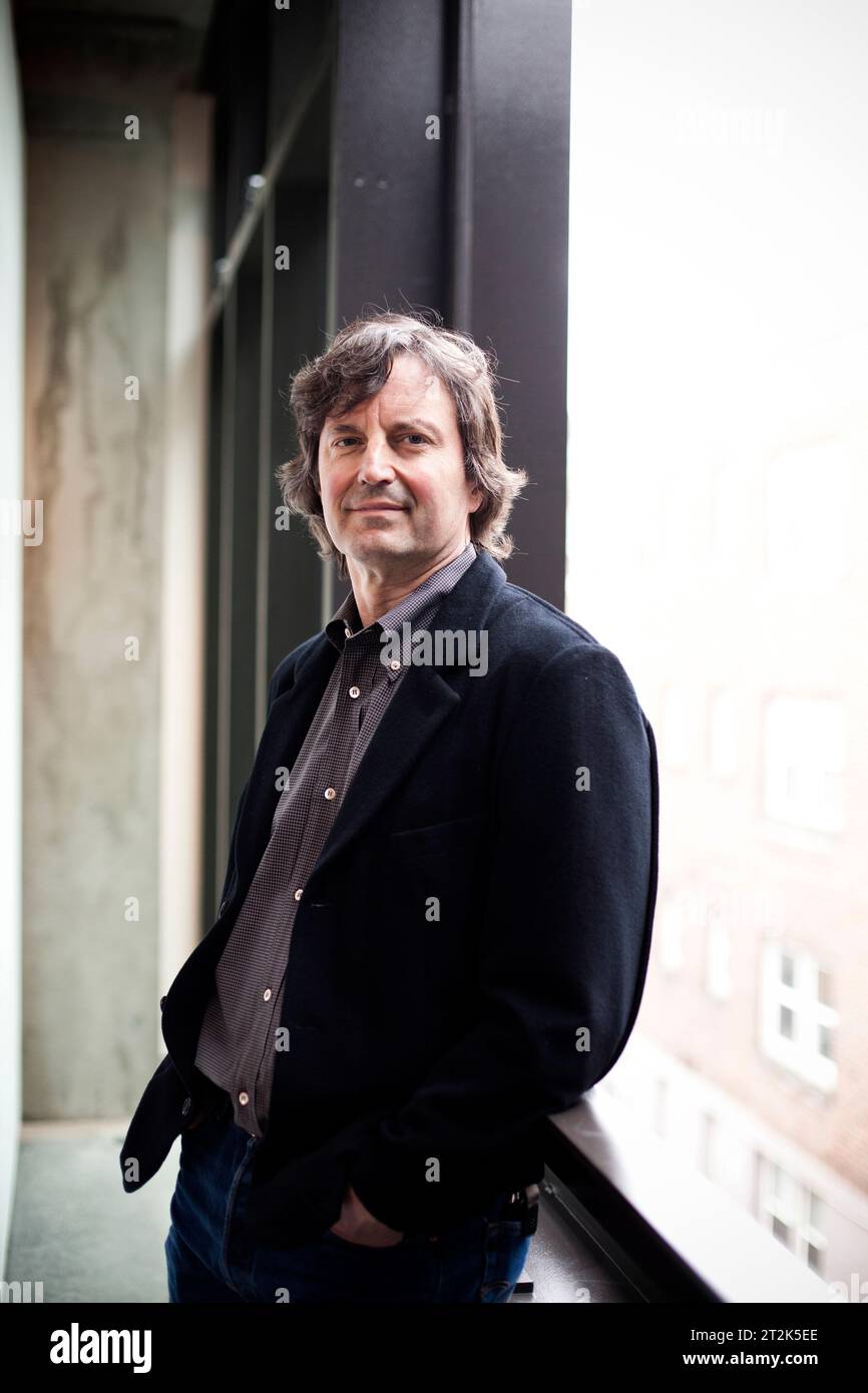 Portrait smiling businessman leaning against window hi-res stock ...