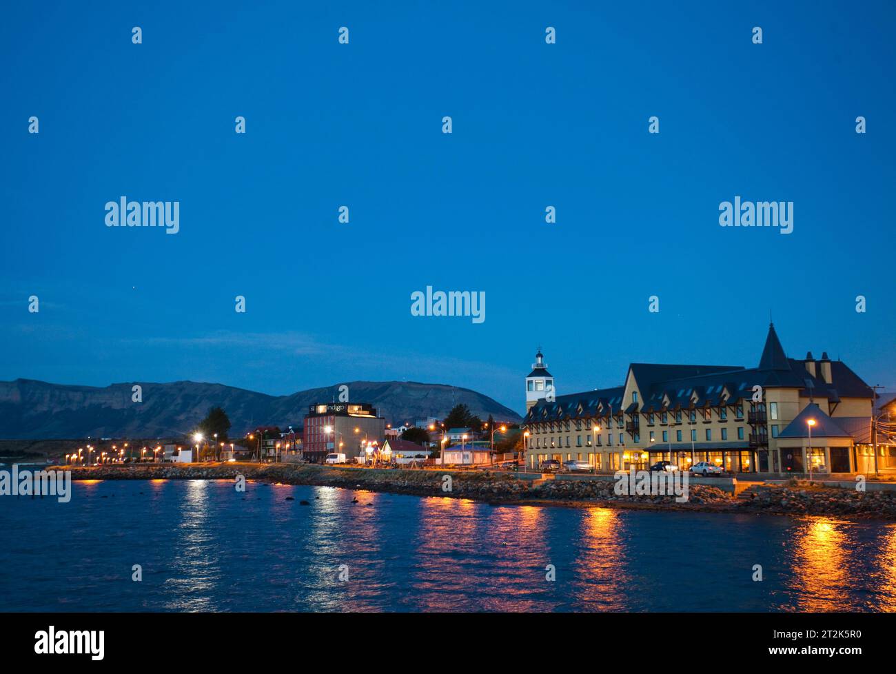 A waterfront town is lit up at night Stock Photo - Alamy