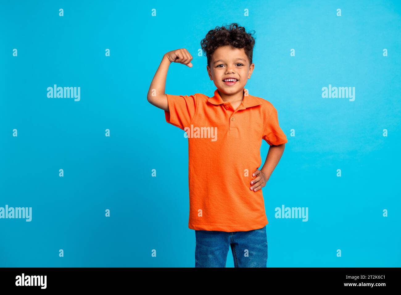 Photo of strong boy little sportsman training show arms with muscles ...