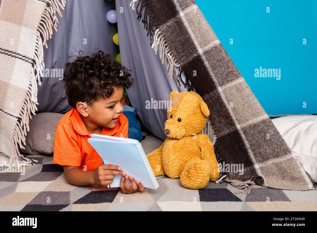 Photo of smart kid boy finish doing homework show copybook toy in ...