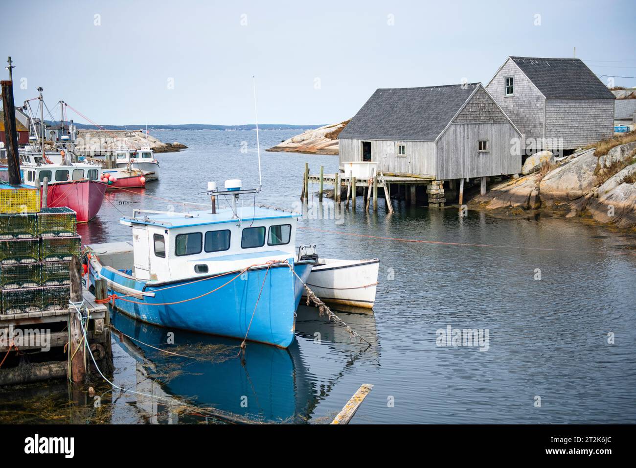 Fishing boats at iconic Peggy's Cove Lighthouse of Nova Scotia Stock ...