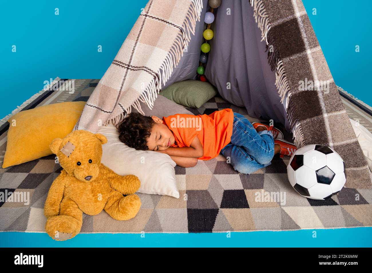 Photo of adorable preschool boy sleeping in homemade tent after weekend ...