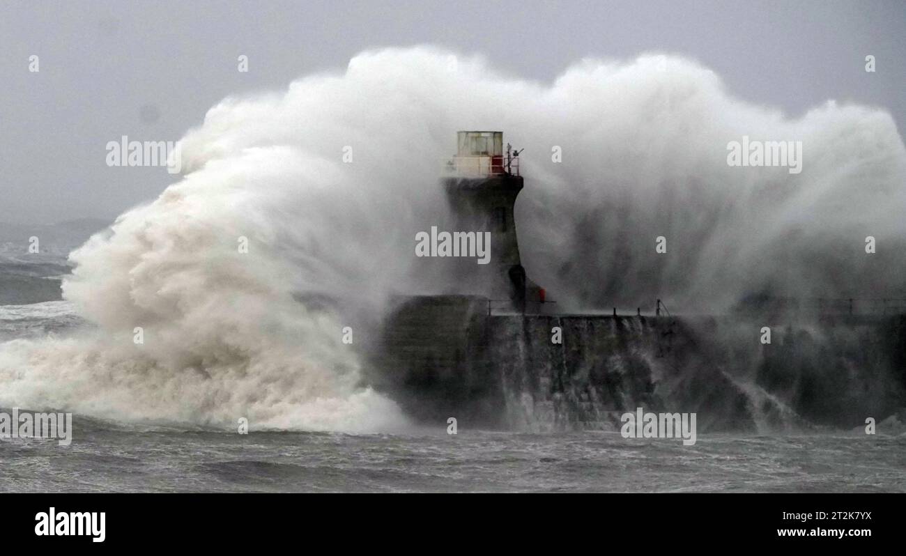 Waves crash against South Shields lighthouse after the top was ripped ...