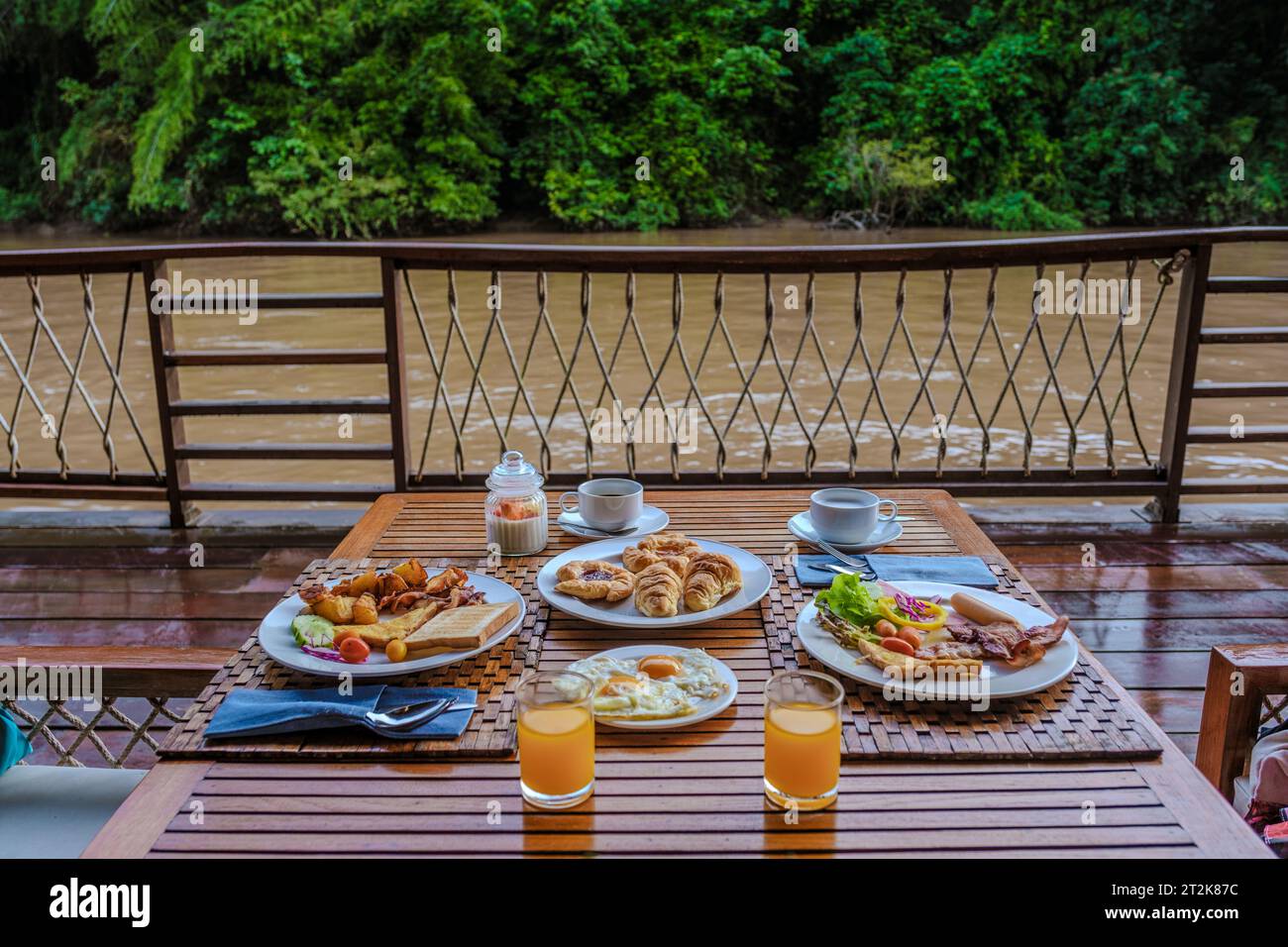 breakfast table at a tropical beach house on the River Kwai in Thailand ...