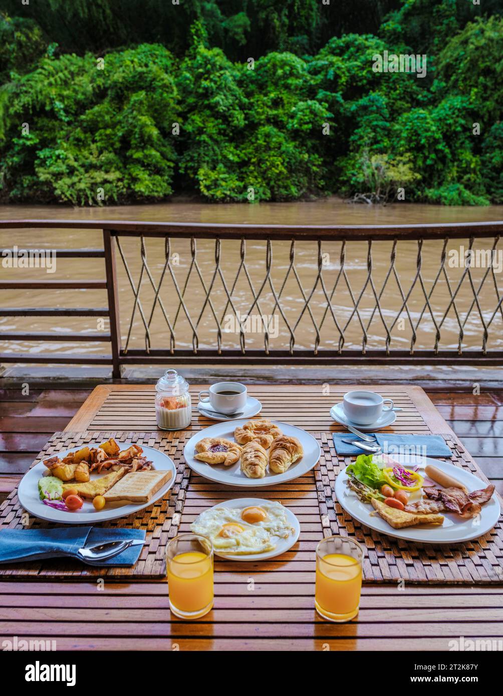 breakfast table at a tropical beach house on the River Kwai in Thailand ...