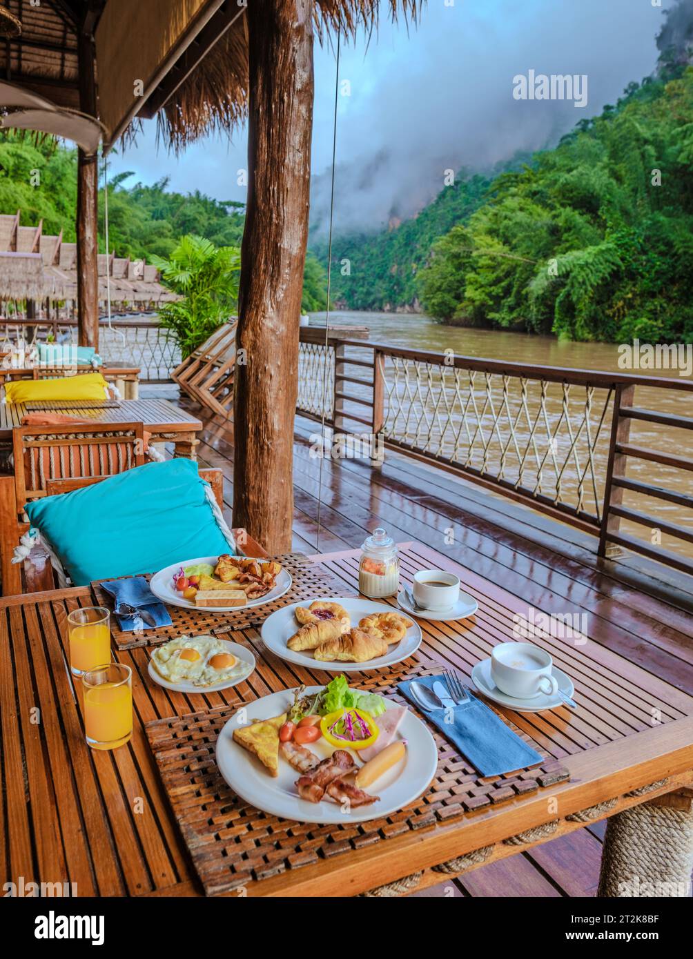 breakfast table at a tropical beach house on the River Kwai in Thailand ...