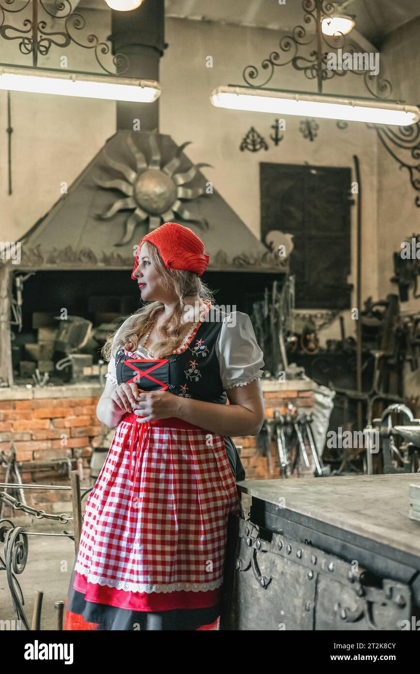 Russian young lady in traditional clothes in a house near a Russian ...