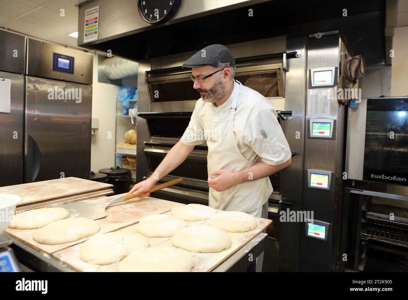 Lead baker Nick Metcalfe preparing Stotties's at the Big River bakery ...