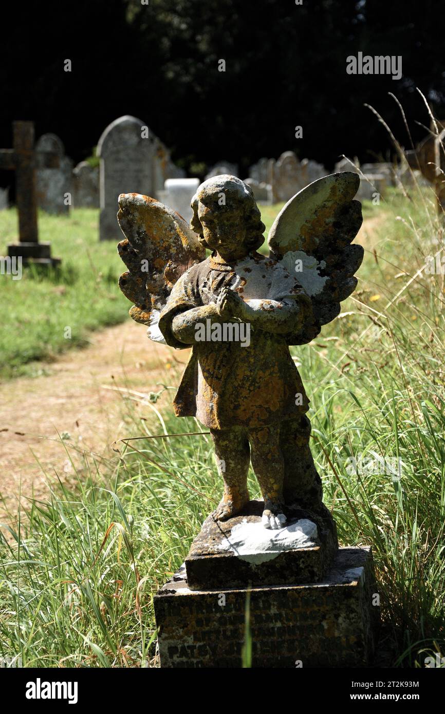 Stone cemetery Angel watching over loved ones in graveyard Stock Photo ...