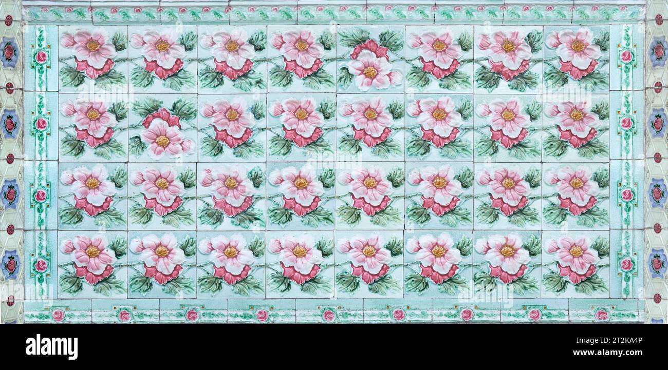 Rows of antique Nyonya Tiles with pink flowers with green background ...