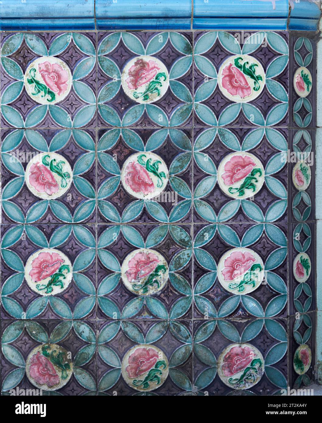 Rows of antique Nyonya Tiles with pink flowers with green background ...