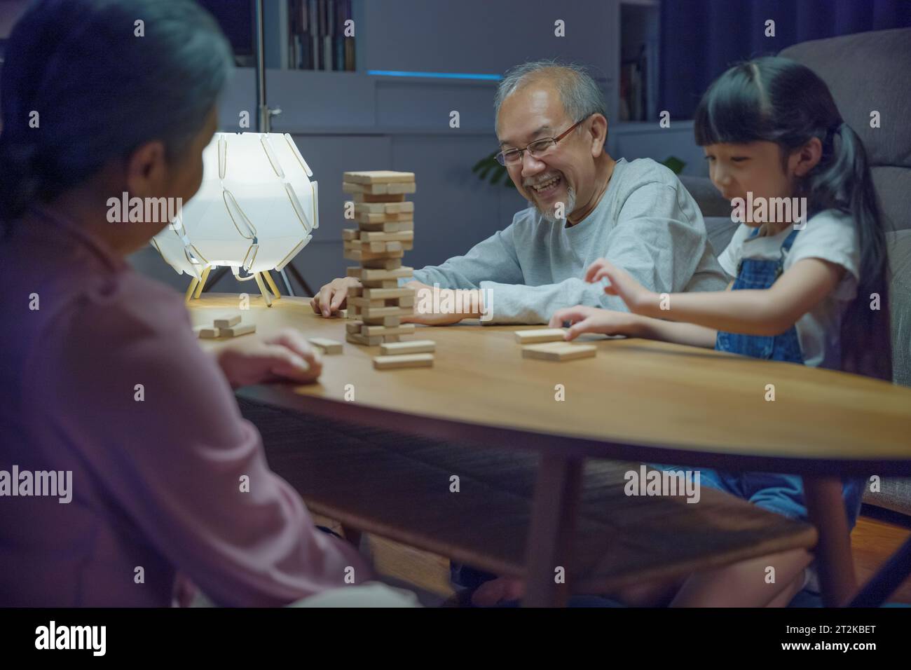 Asian family enjoy playing toy block with little daughter together in home living room Stock ...