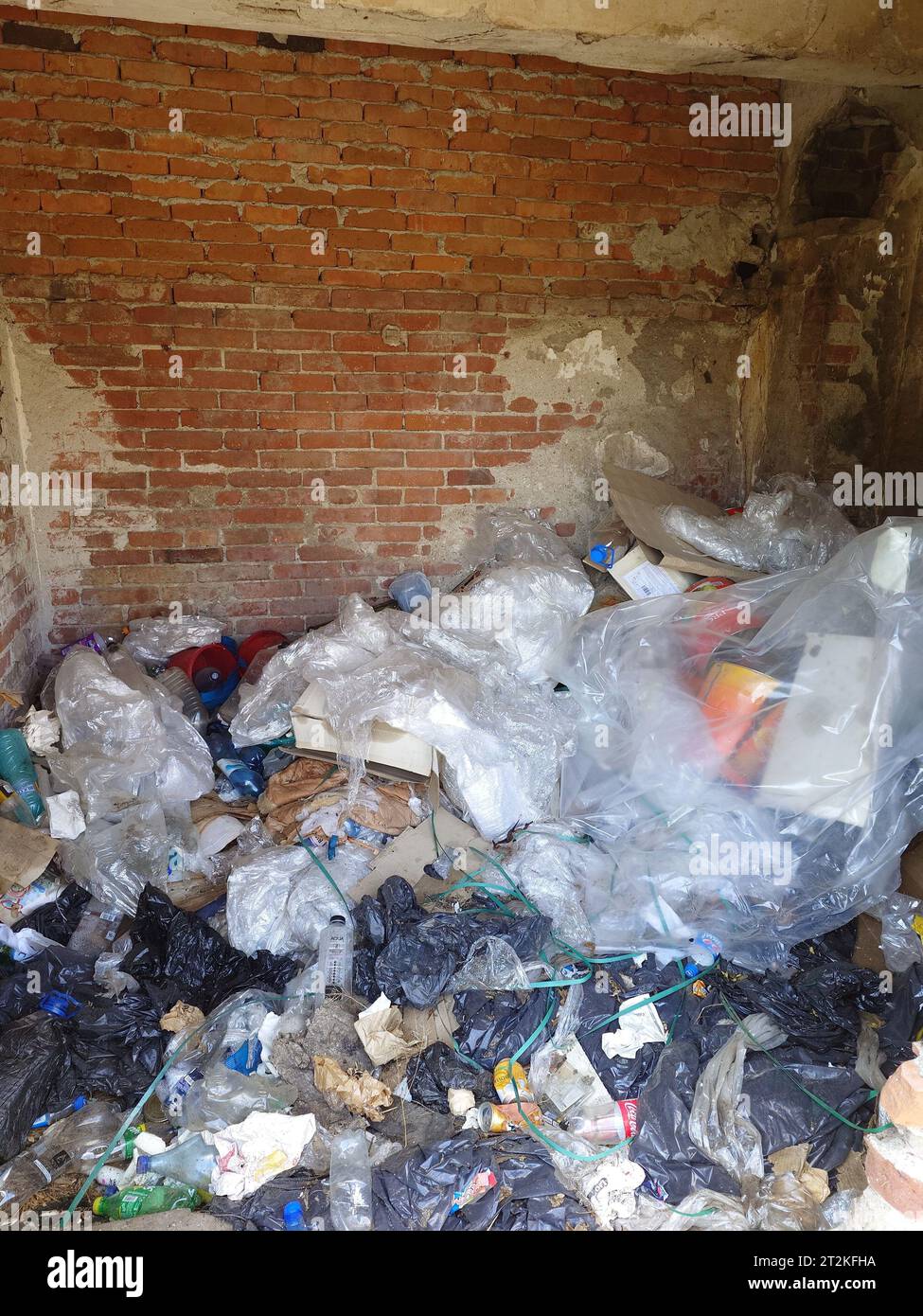 A pile of plastic bags trash inside a run down and abandoned home ...
