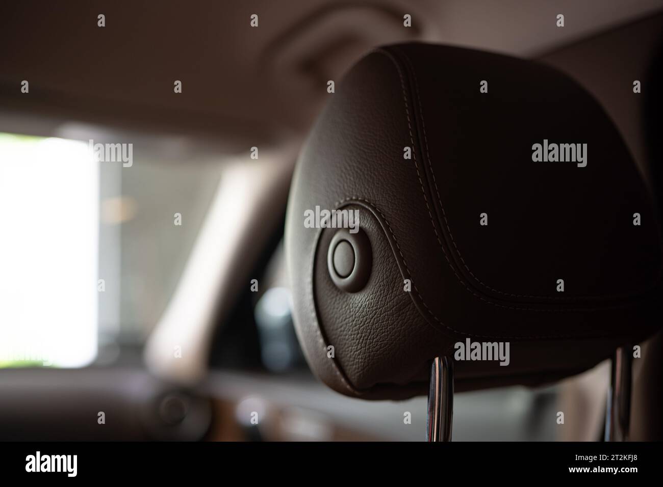 Modern car leather trimmed seat head rest. Close up shot, shallow depth ...