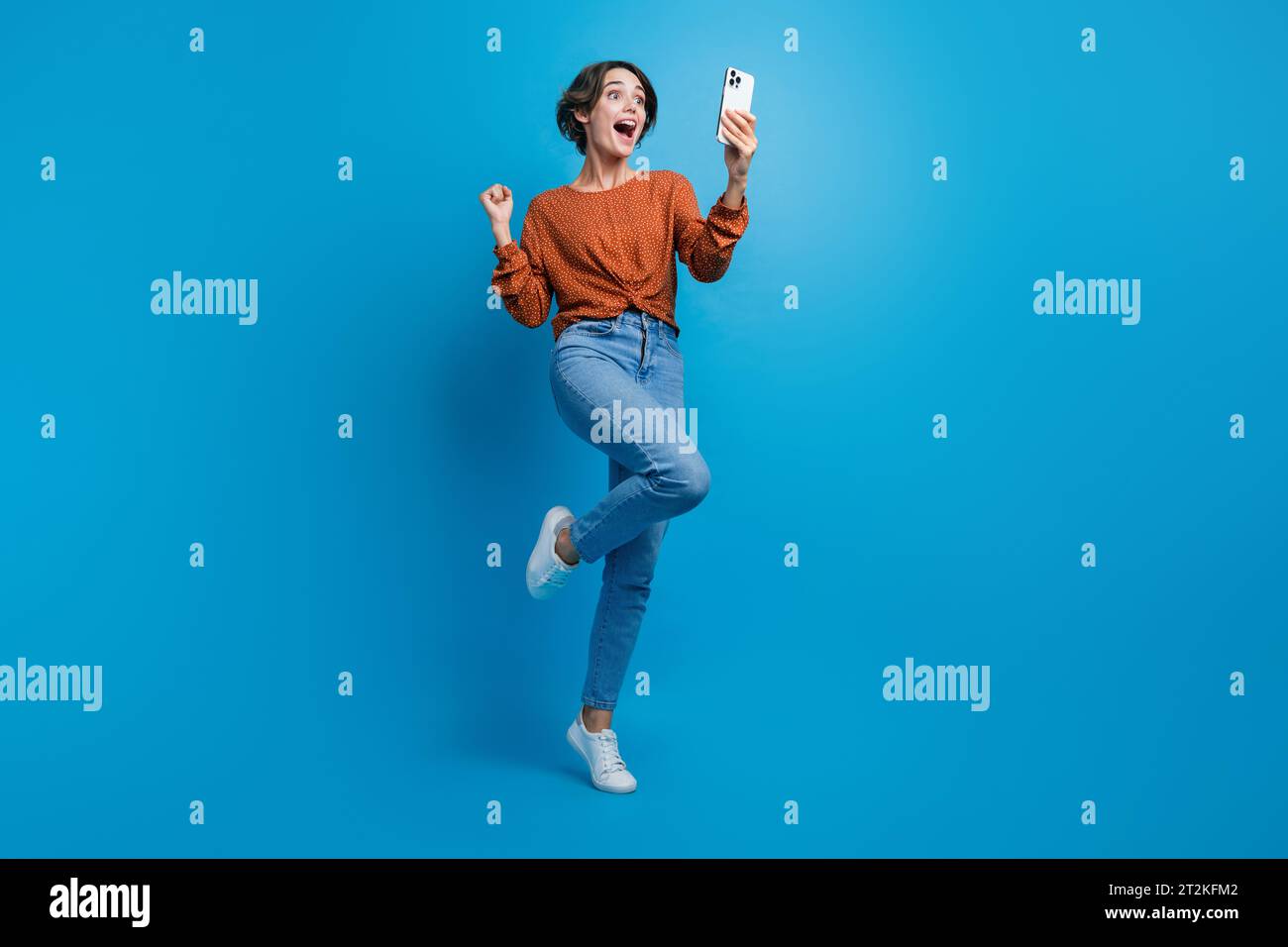 Full length photo of lovely young lady celebrate big discount eshop ...