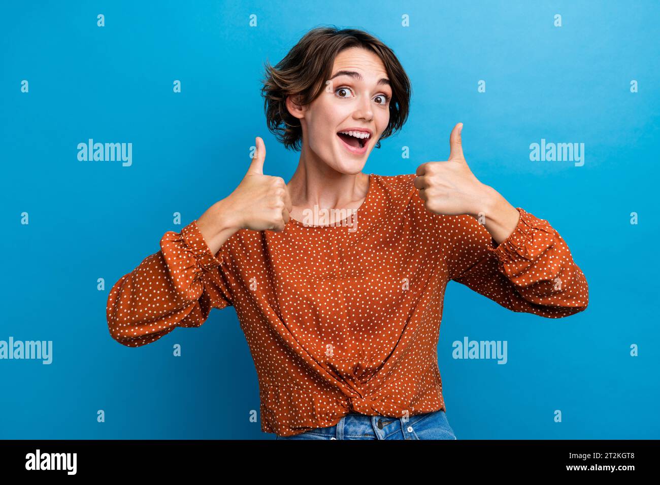 Photo of funny pretty girl raise hands thumb fingers up put like get ...