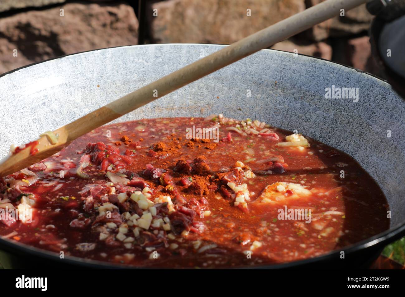 Meat and vegetables in a goulash kettle on a fire pit Stock Photo - Alamy