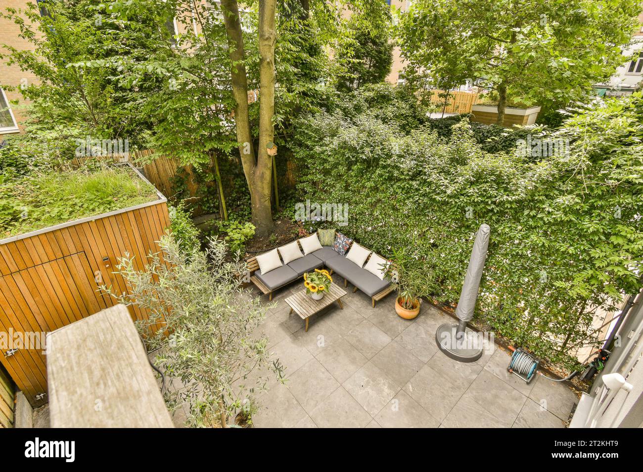an outdoor living area with furniture and trees in the back yard ...