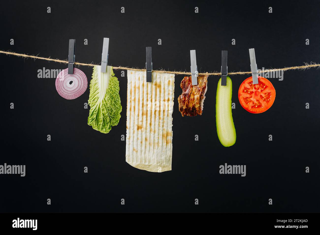 Shawarma ingredients hanging on thread in air : beef meat, lettuce ...