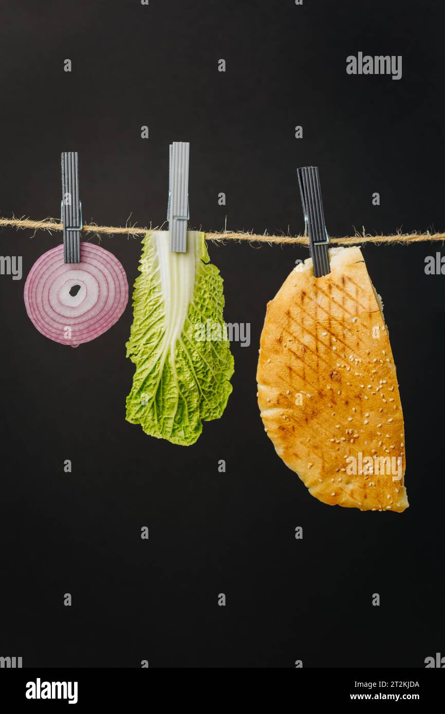 Doner kebab ingredients hanging on thread in air : beef meat, lettuce ...