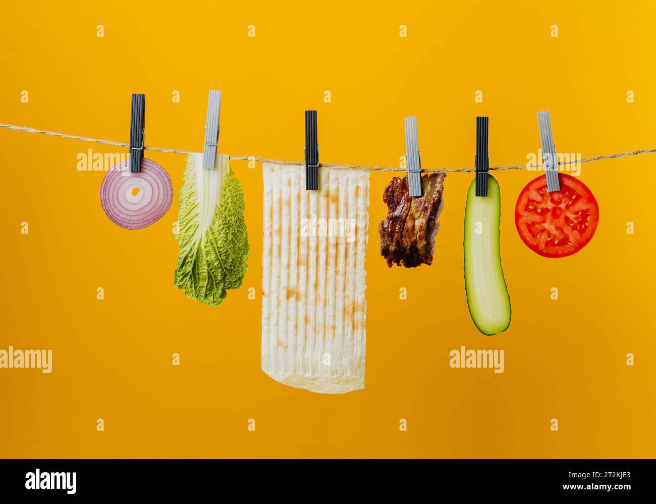 Shawarma ingredients hanging on thread in air : beef meat, lettuce ...