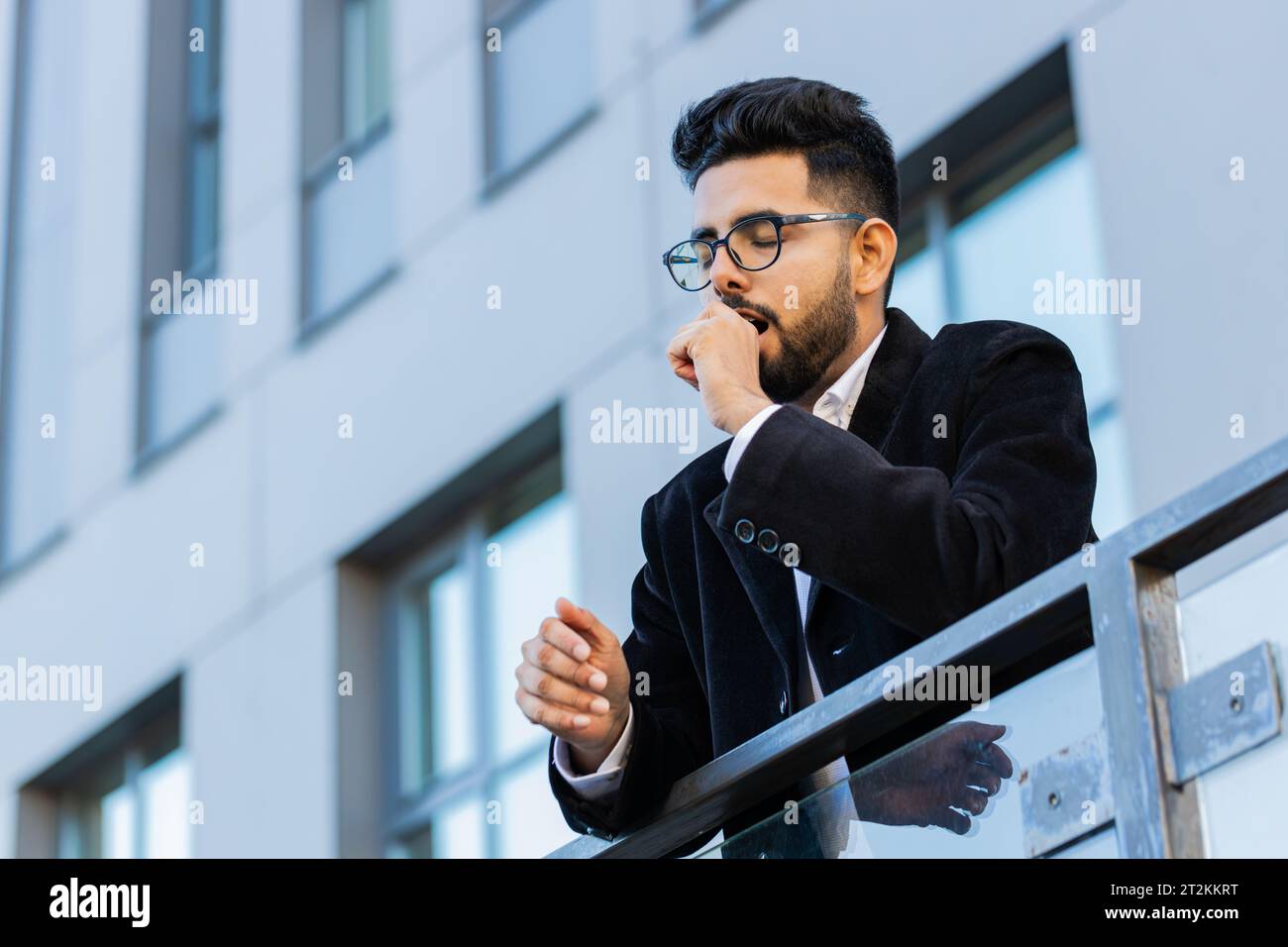 Tired exhausted Indian businessman yawning, sleepy inattentive feeling ...
