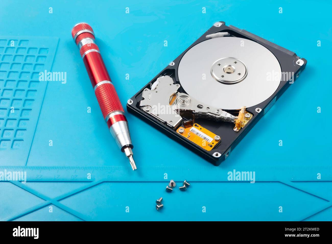 Hard drive, open, interior with trays and head, on an antistatic mat ...