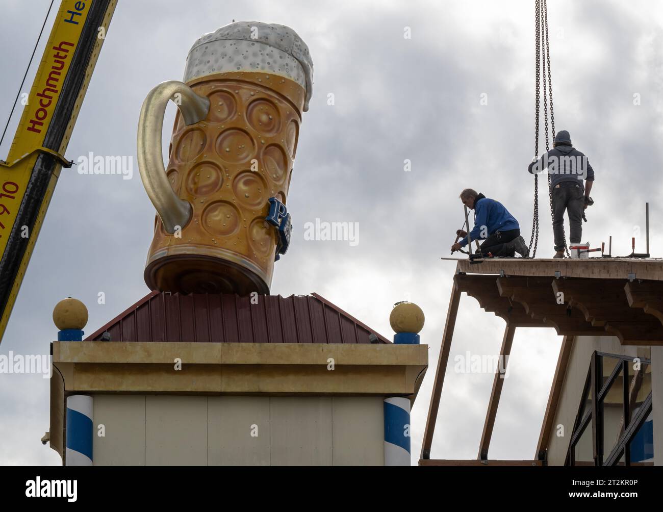 Munich, Germany. 20th Oct, 2023. Two men dismantle the roof structure ...