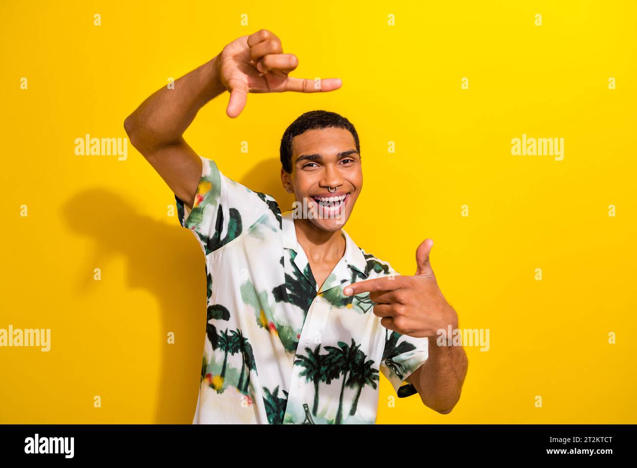 Photo of cheerful positive man with nose piercing dressed palm print ...