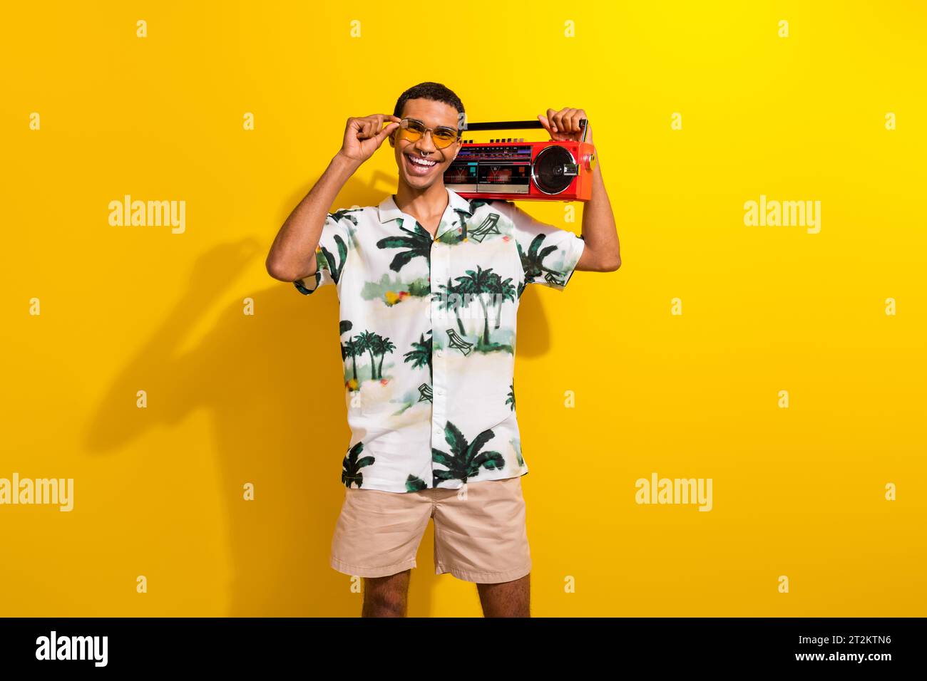 Photo portrait of handsome young guy hold tape recorder dancing wear ...