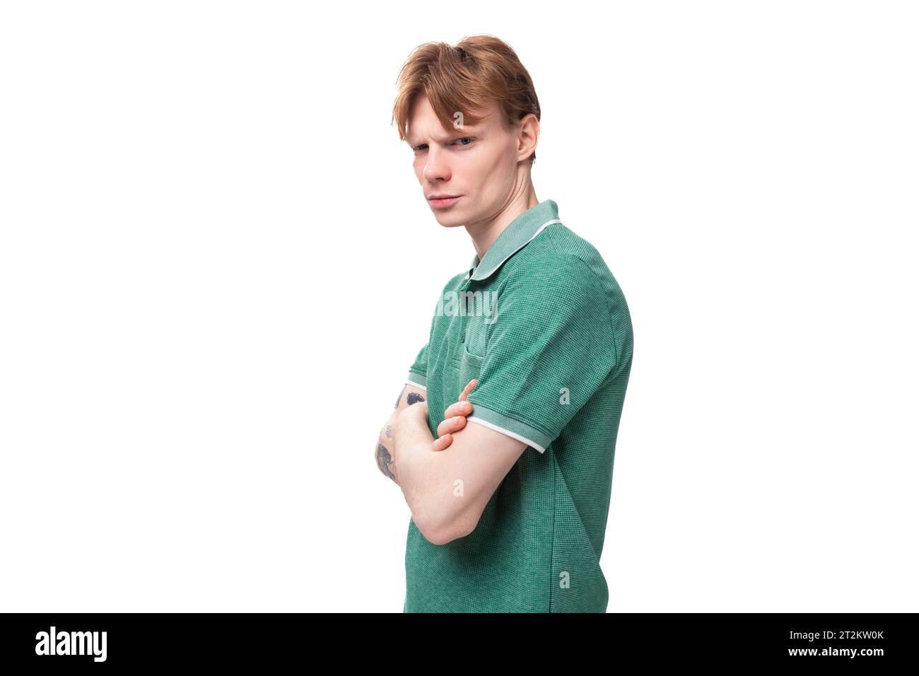 a young slender ginger man with a tattoo on his arm, dressed in a green ...