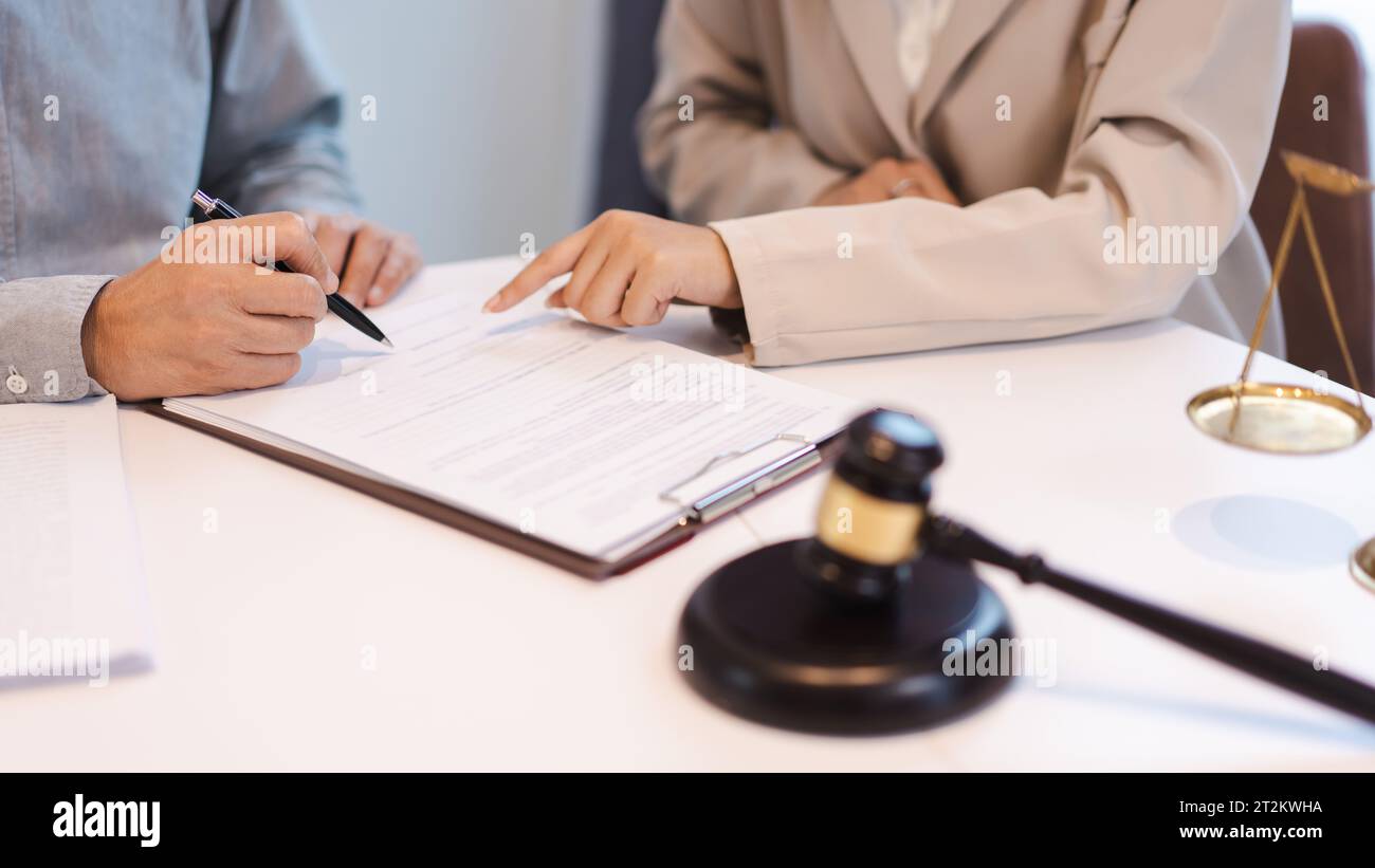 Female lawyer explaining legal agreement with senior businessman and ...