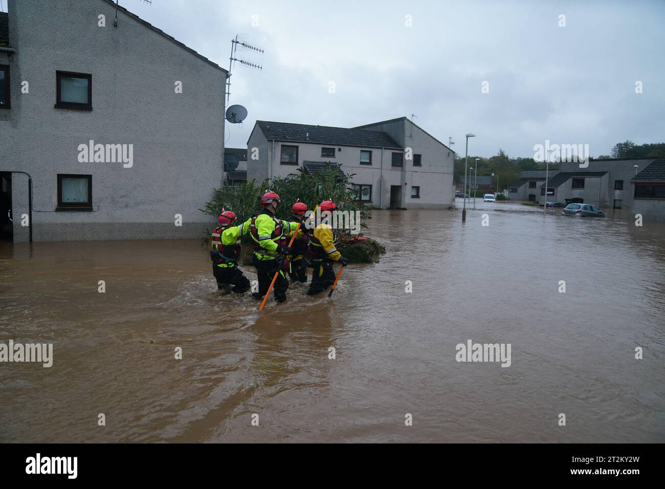 Emergency workers wade through flood water in Brechin, Scotland, as ...