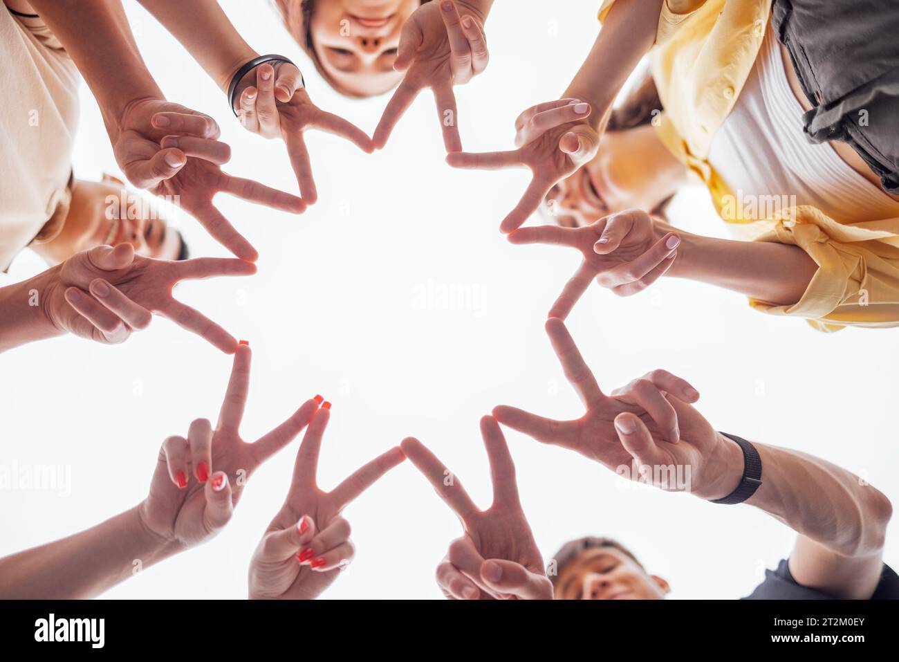 Teenagers hands making a star. Male and female palms in circle. Five funny laughing teens ...