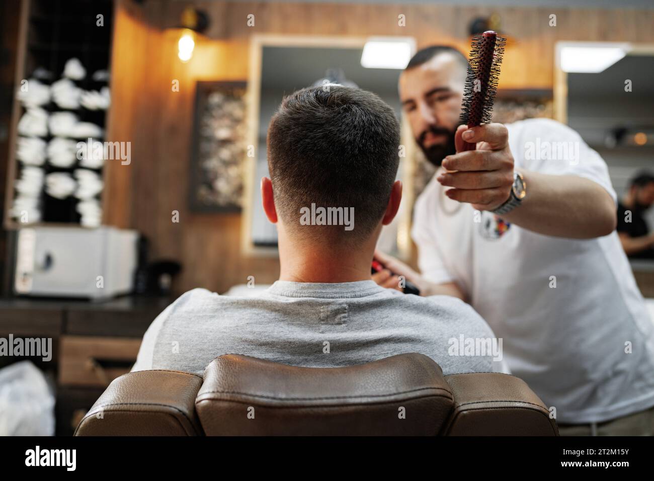 ISTANBUL, TURKEY - MAY 16, 2022: Hairstylist doing haircut for client ...