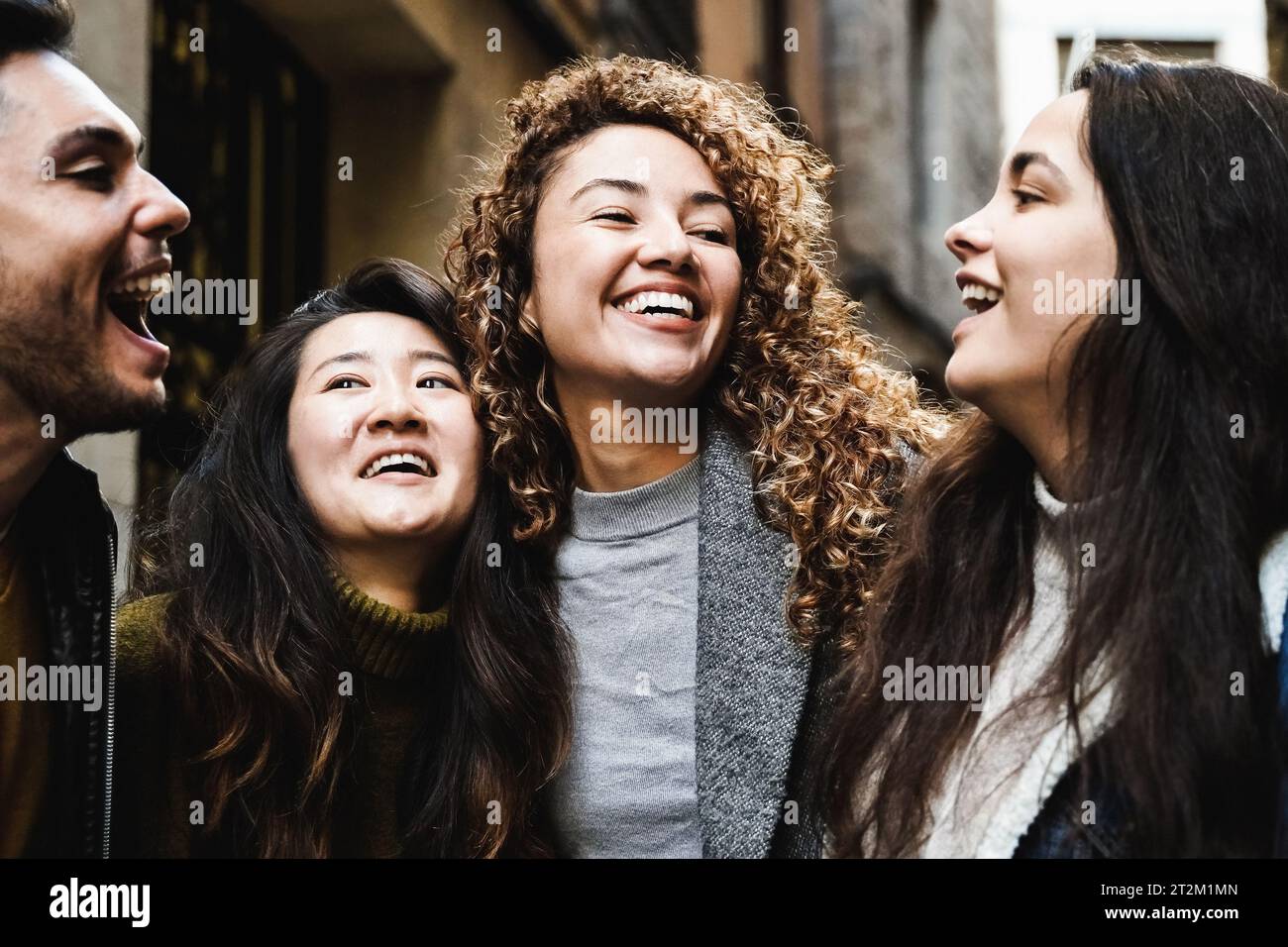 Multicultural young people having fun together outside - Happy friends ...