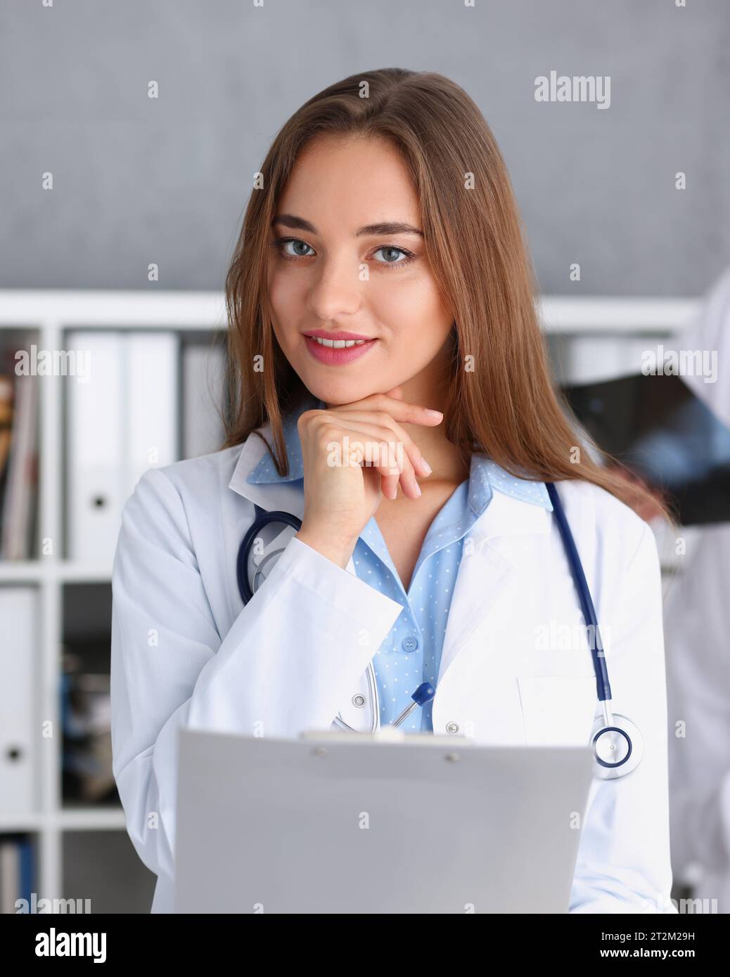 Beautiful smiling female doctor stand in office Stock Photo - Alamy