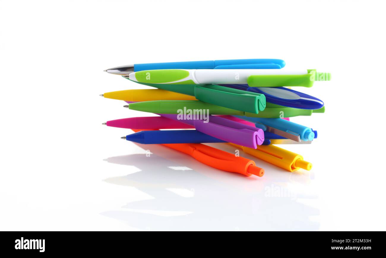Multi colored ball pens on white background Stock Photo - Alamy