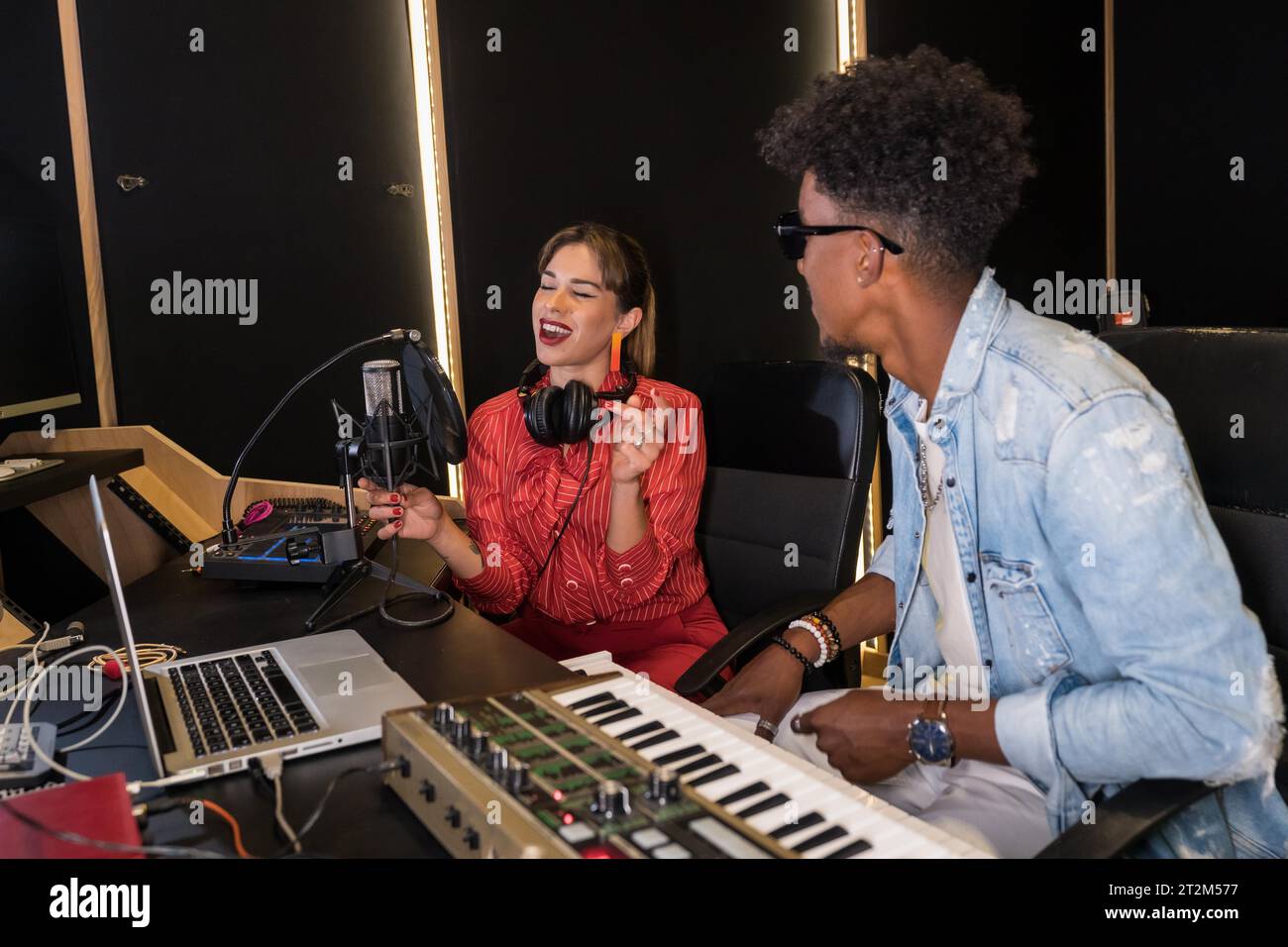 Female singer composing and recording new album in studio next to an ...