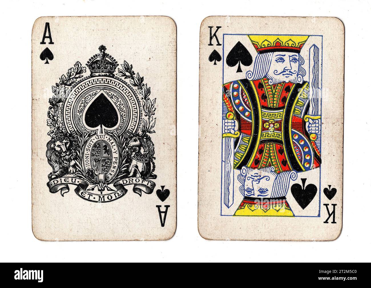 A pair of vintage playing cards showing an ace and king of spades on a ...